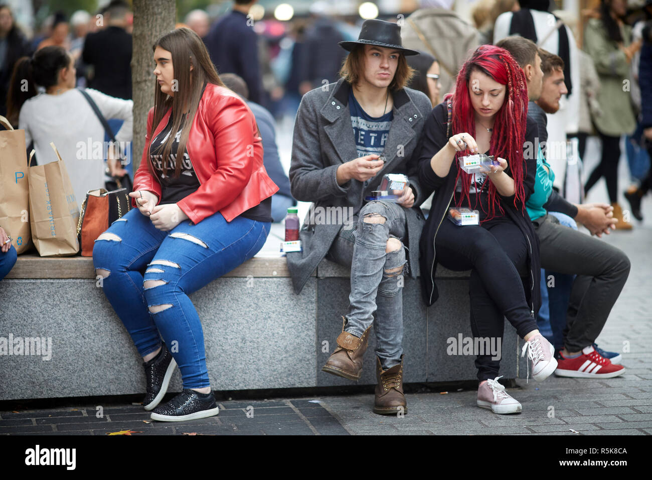Liverpool city centre people resting on street furniture benches Stock ...