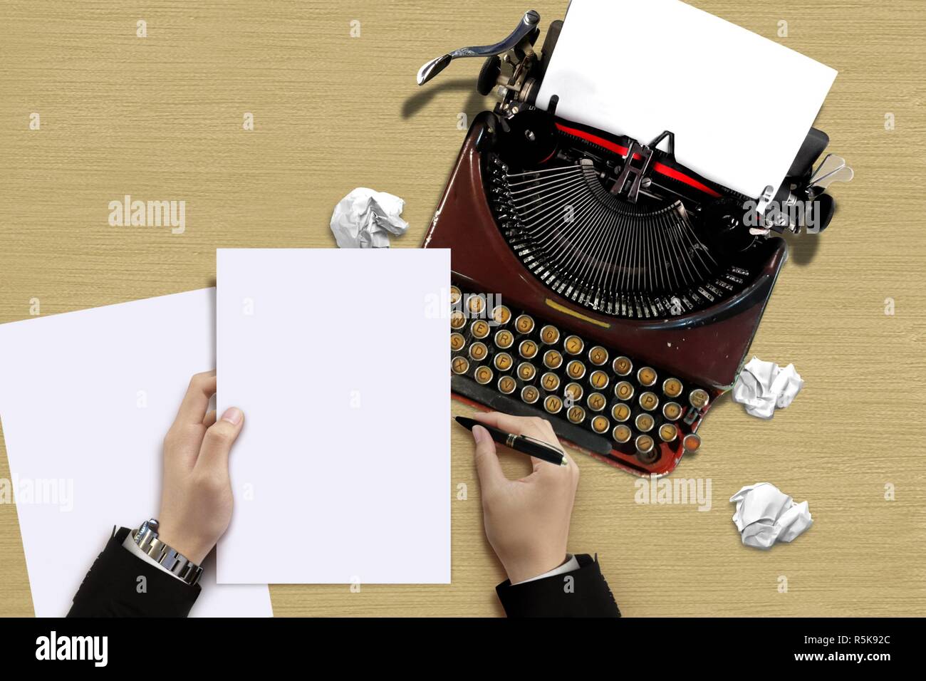 Vintage typewriter with author hand checking a paper sheets Stock Photo ...