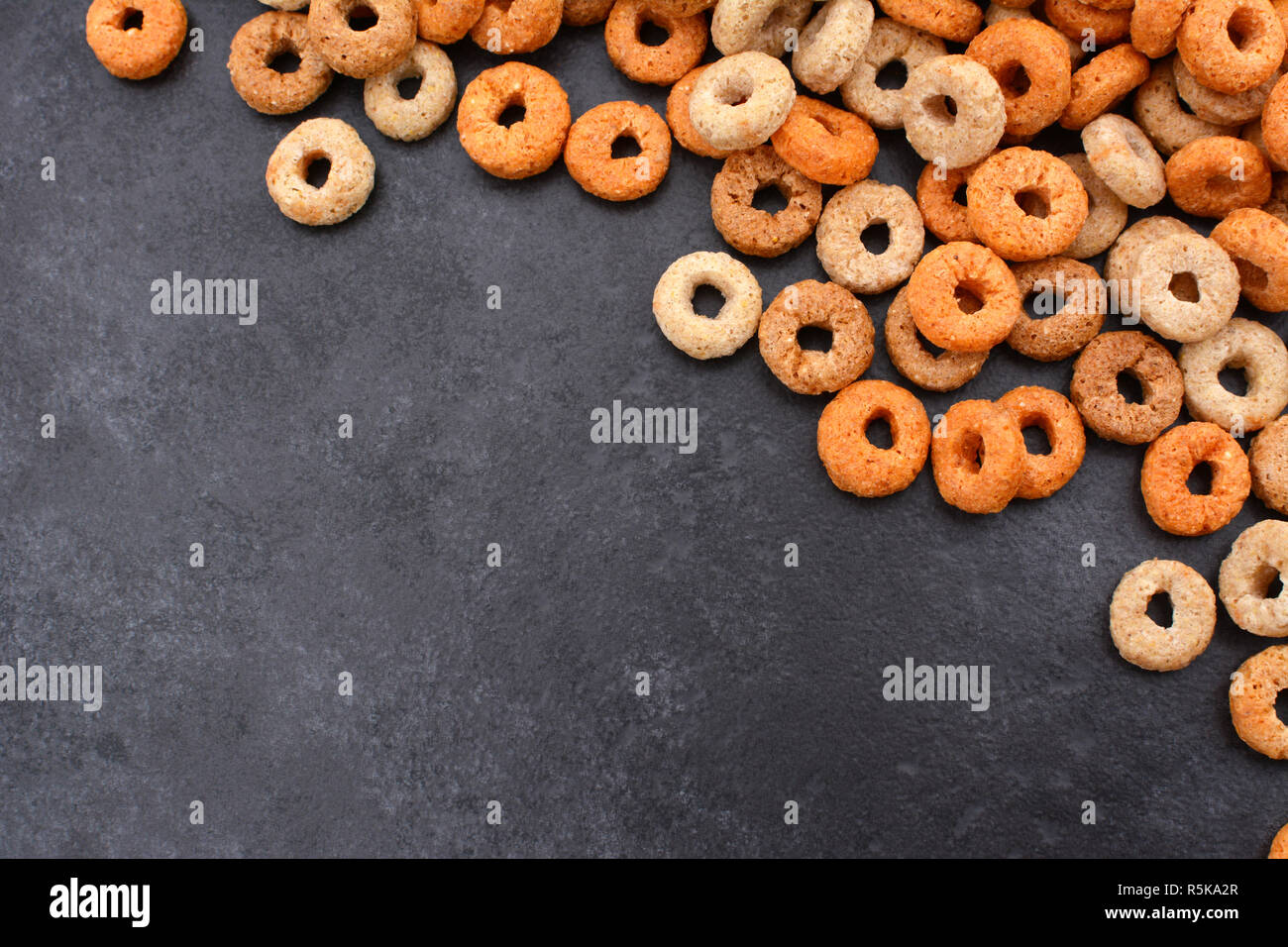 Multigrain hoops breakfast cereal diagonal border on grey slate Stock ...