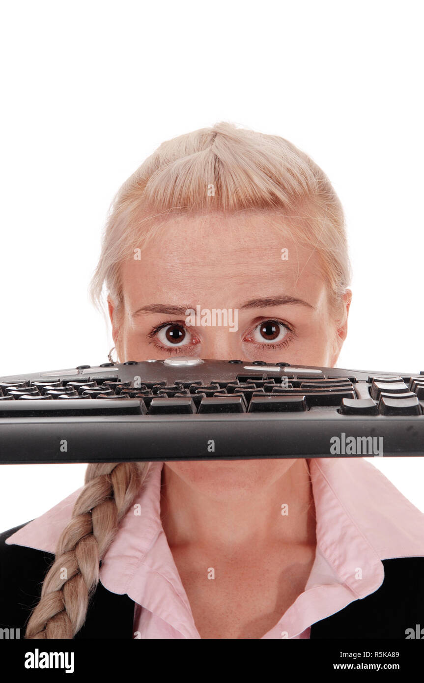Woman holding the keyboard over her face Stock Photo - Alamy