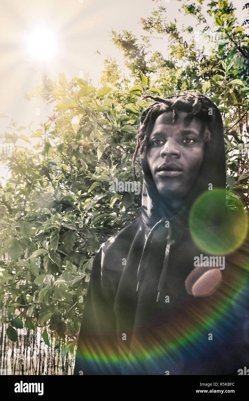 Young man with the sun behind and iridescent reflections Stock Photo ...
