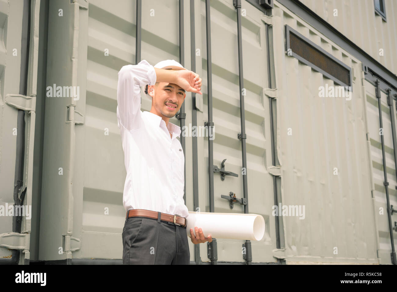 Young asian engineer tired at construction site building Stock Photo ...
