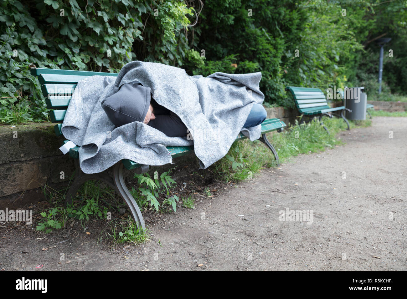 Homeless Man Sleeping On Bench Stock Photo - Alamy