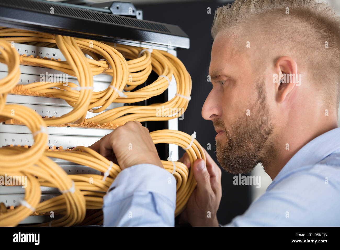 Technician Checking Server's Wires In Data Center Stock Photo - Alamy
