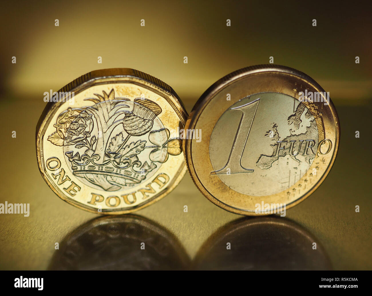 1 pound and 1 euro coin over metal background Stock Photo - Alamy