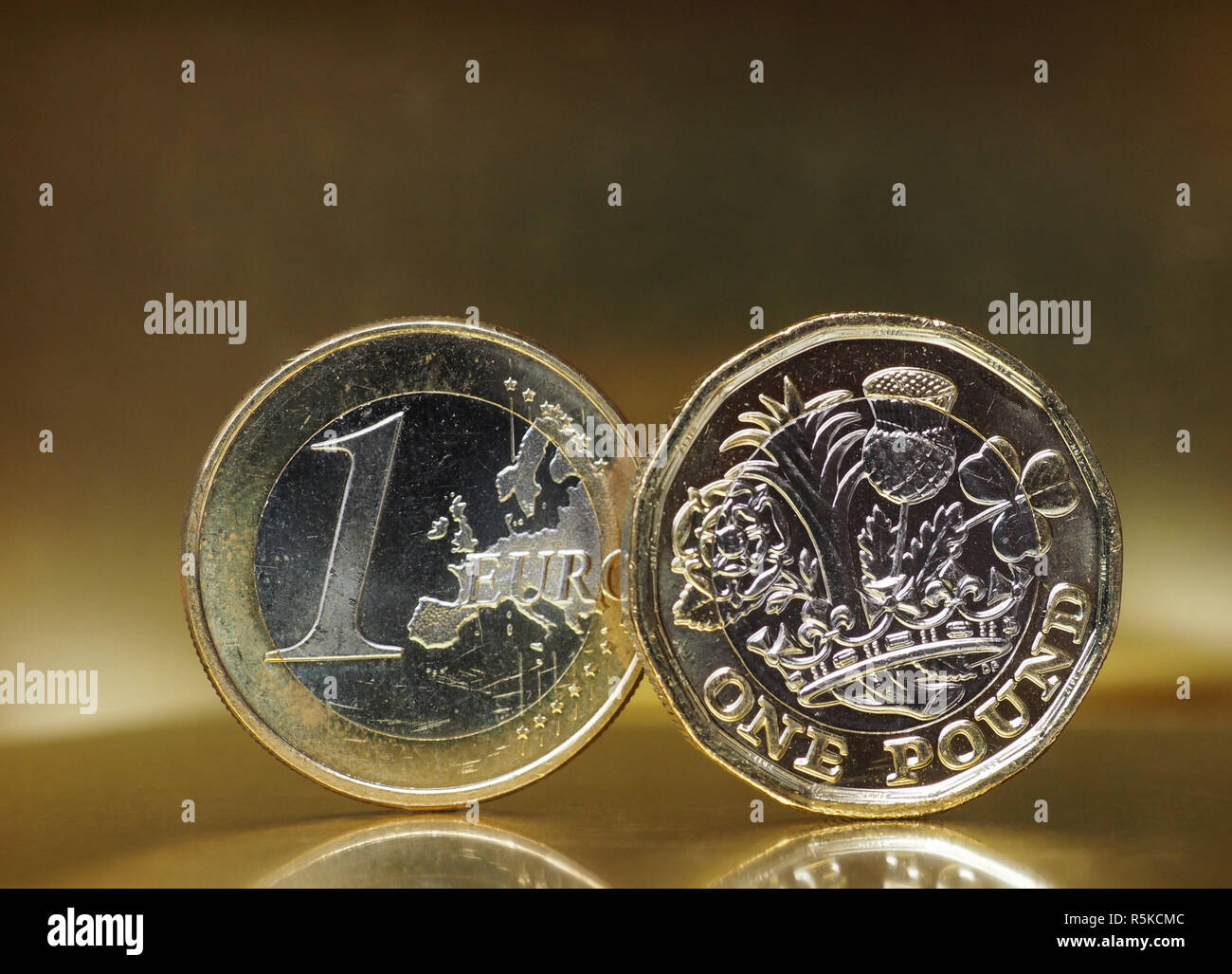1 pound and 1 euro coin over metal background Stock Photo - Alamy