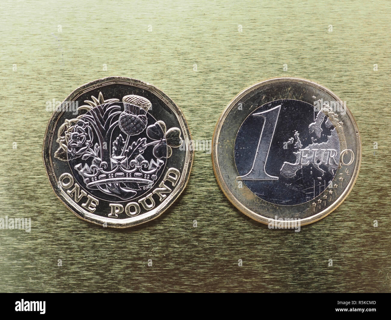 1 pound and 1 euro coin over metal background Stock Photo - Alamy