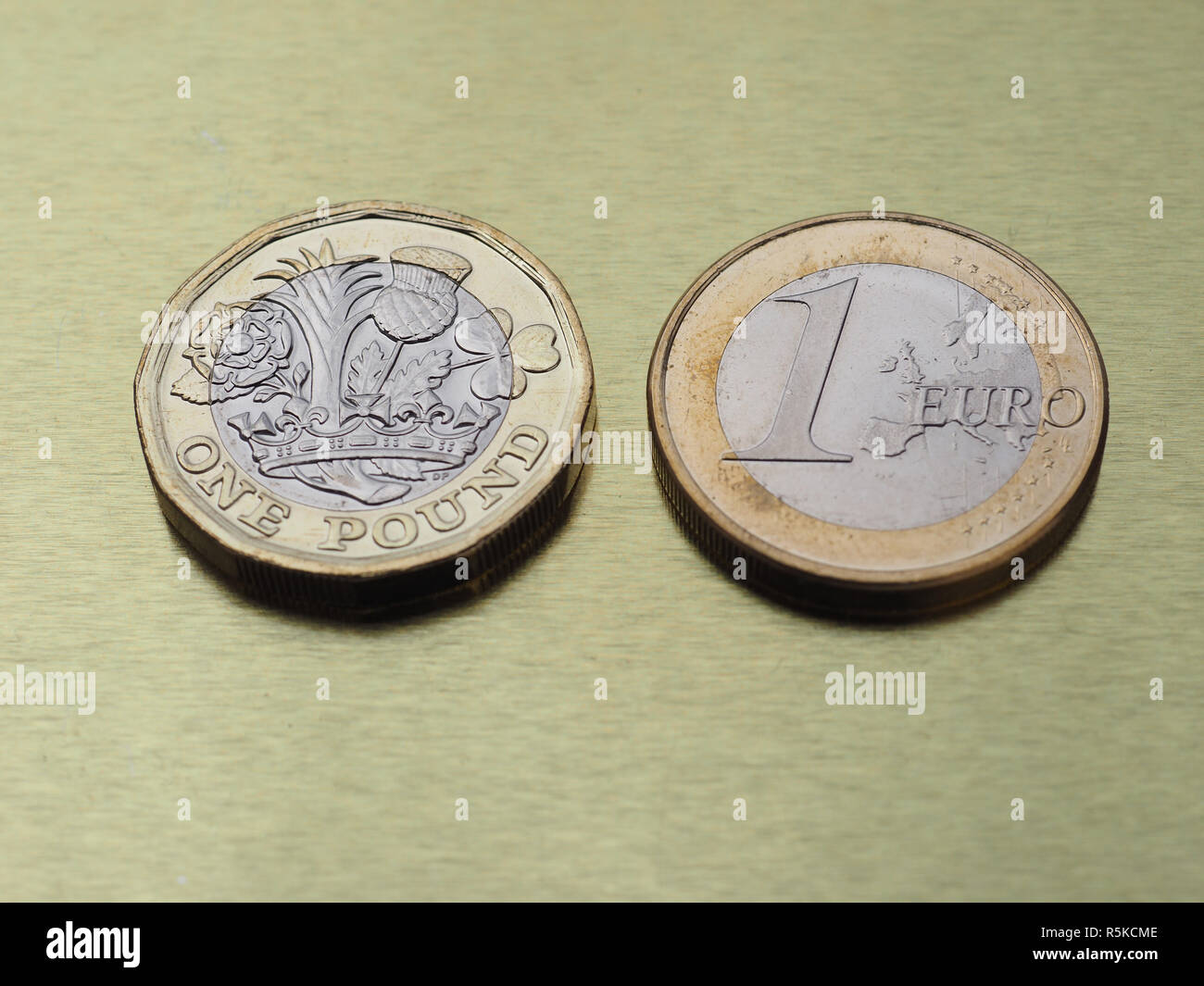 1 pound and 1 euro coin over metal background Stock Photo - Alamy