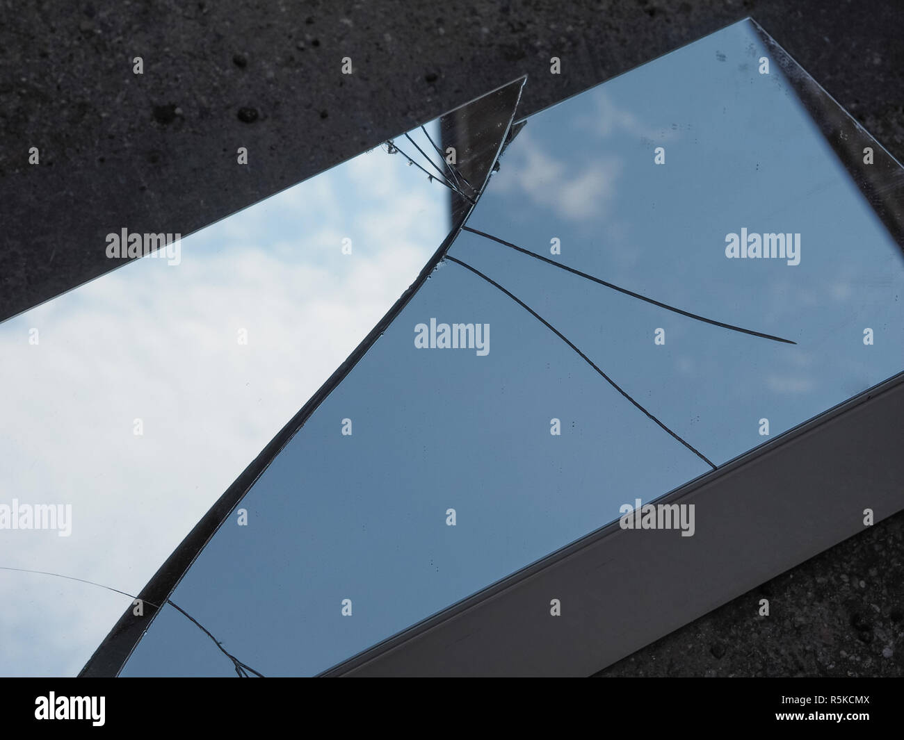 blue sky with clouds reflected on broken mirror Stock Photo - Alamy