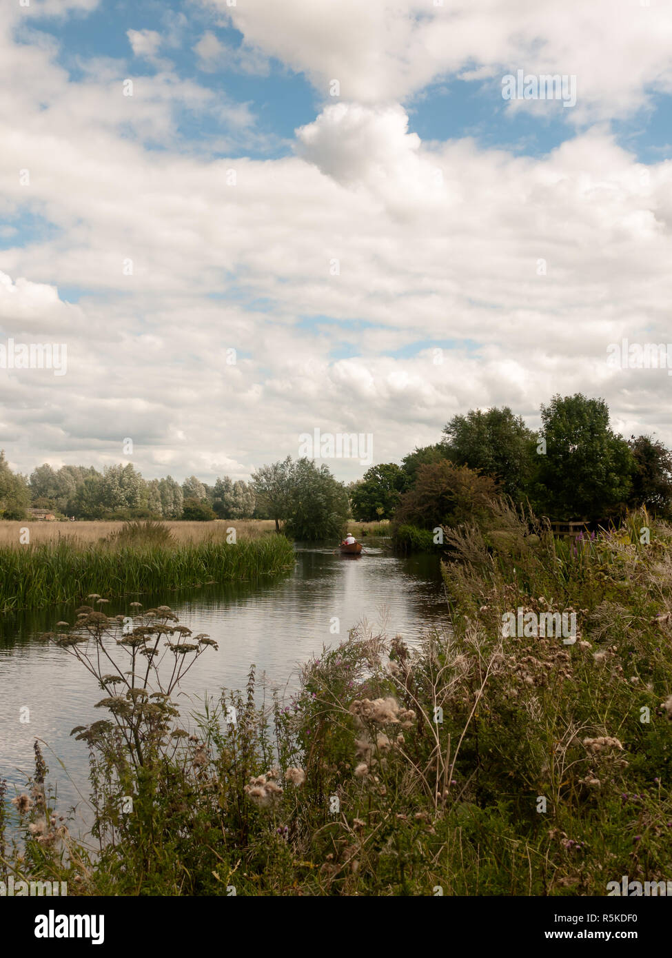river side scene outside with row boat in distance of country Stock ...