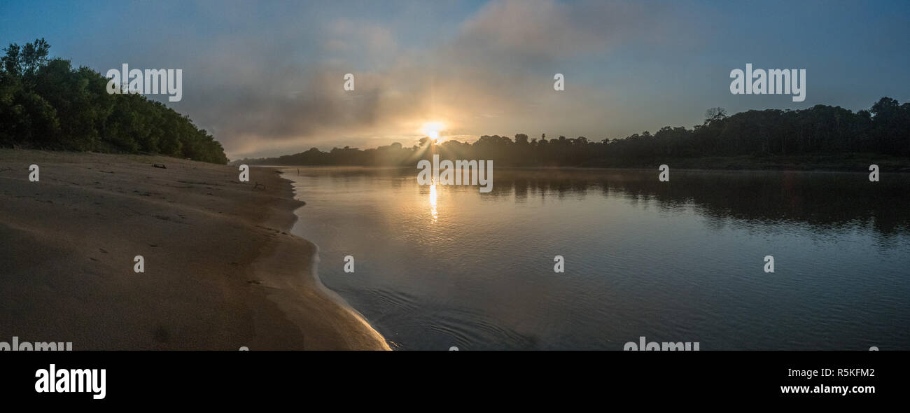 Sunrise over the Javarii river, tributary of the Amazon. Sandy beach in ...