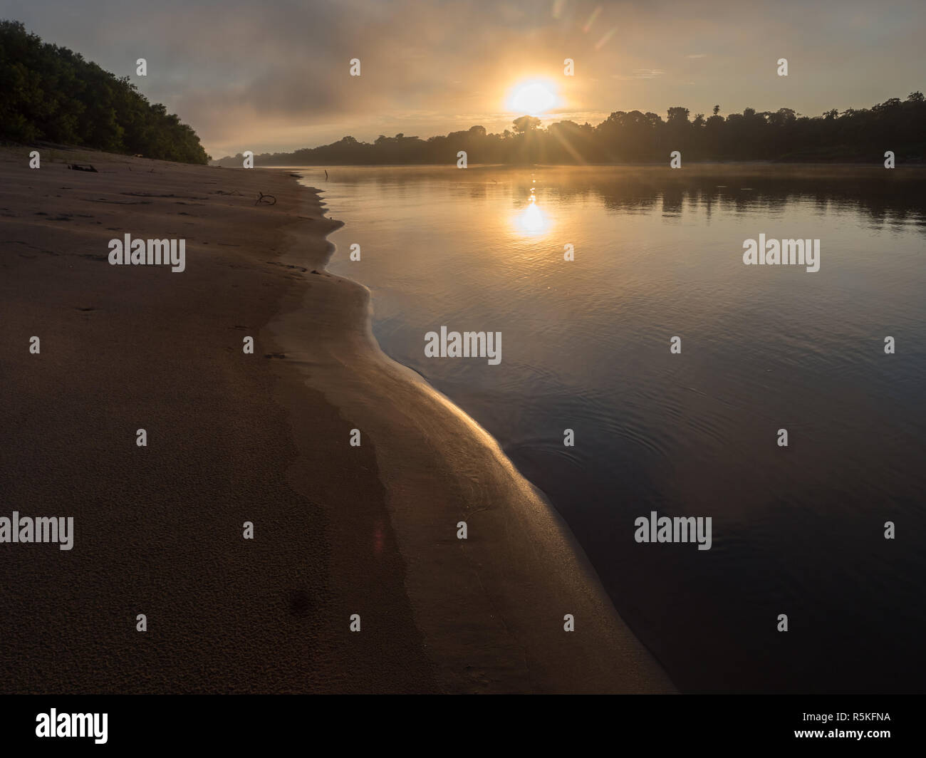 Sunrise over the Javarii river, tributary of the Amazon. Sandy beach in ...