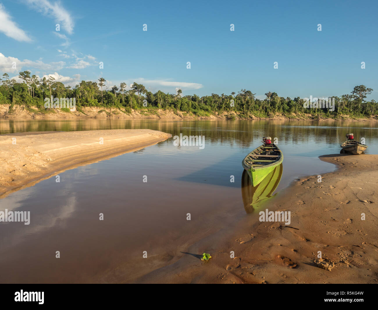 Wooden boats on the sandy beach at the Javari River, the tributary of ...