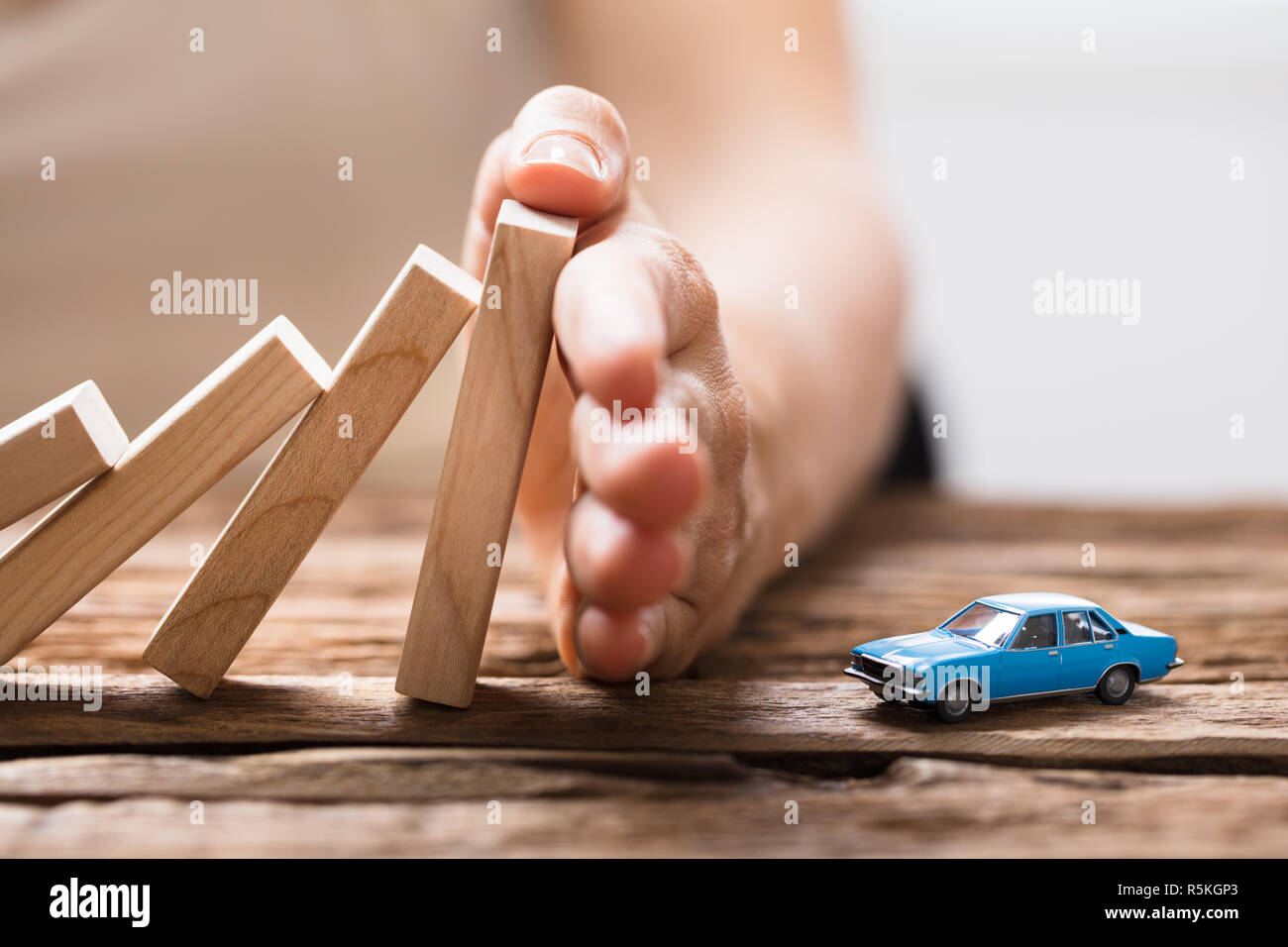 Person Stopping Falling Wooden Blocks Stock Photo - Alamy