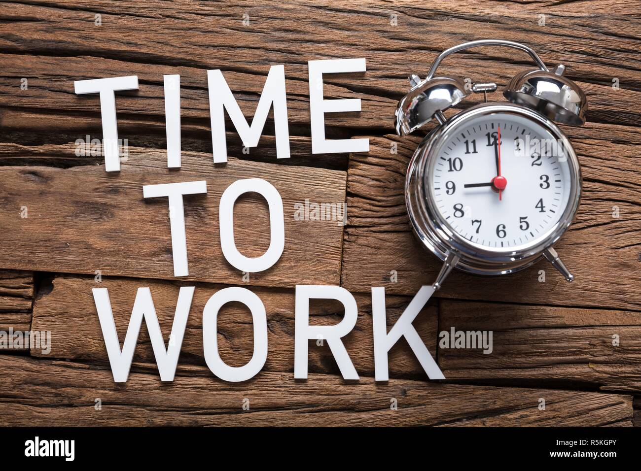 Time To Work Text By Alarm Clock Stock Photo - Alamy