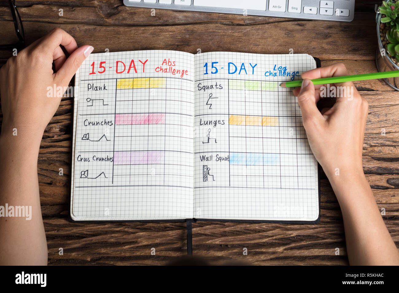 Human Hand Making Exercise Plan On Notebook Stock Photo - Alamy