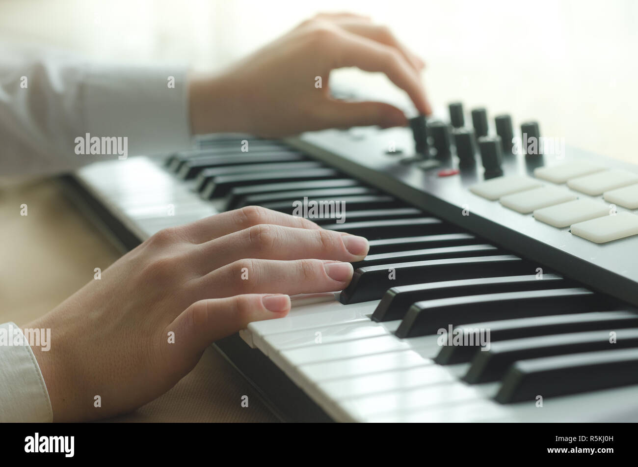 Female adjust the synthesizer Stock Photo - Alamy