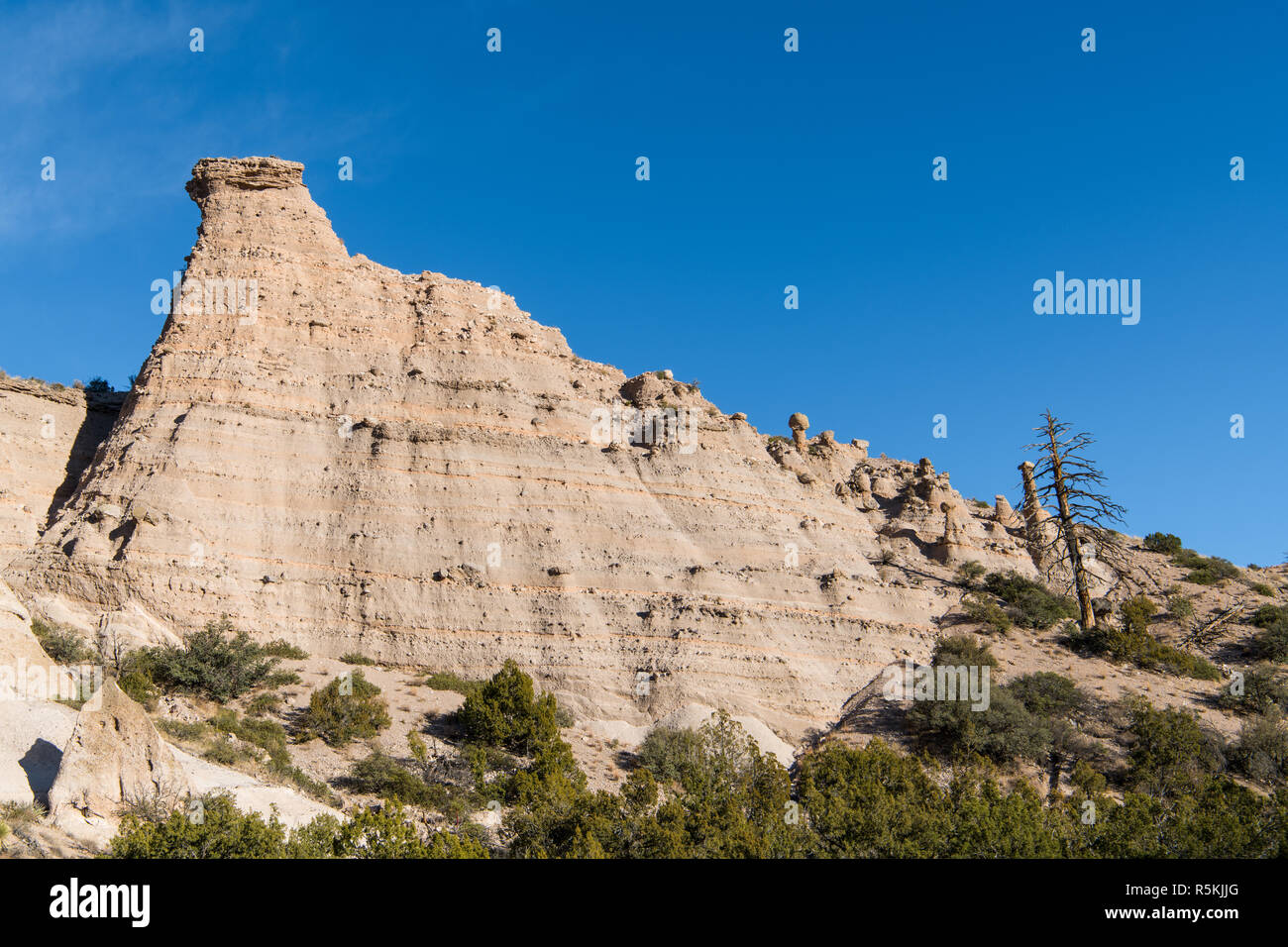 High, steep rock formation showing layers of strata at Kasha-Katuwe ...