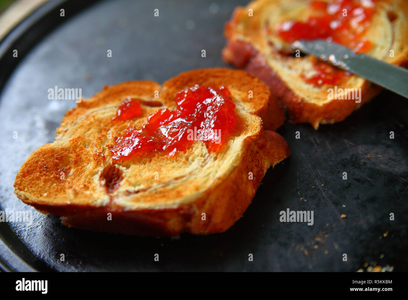 Raspberry jam on toast Stock Photo - Alamy