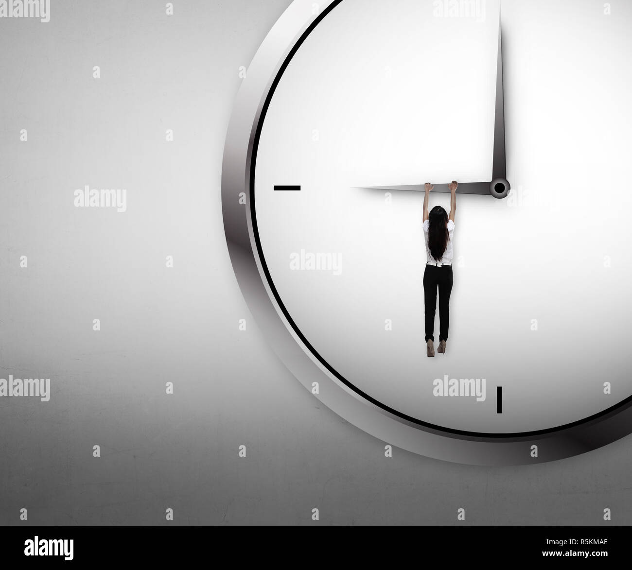Asian business woman hanging on the clock Stock Photo - Alamy