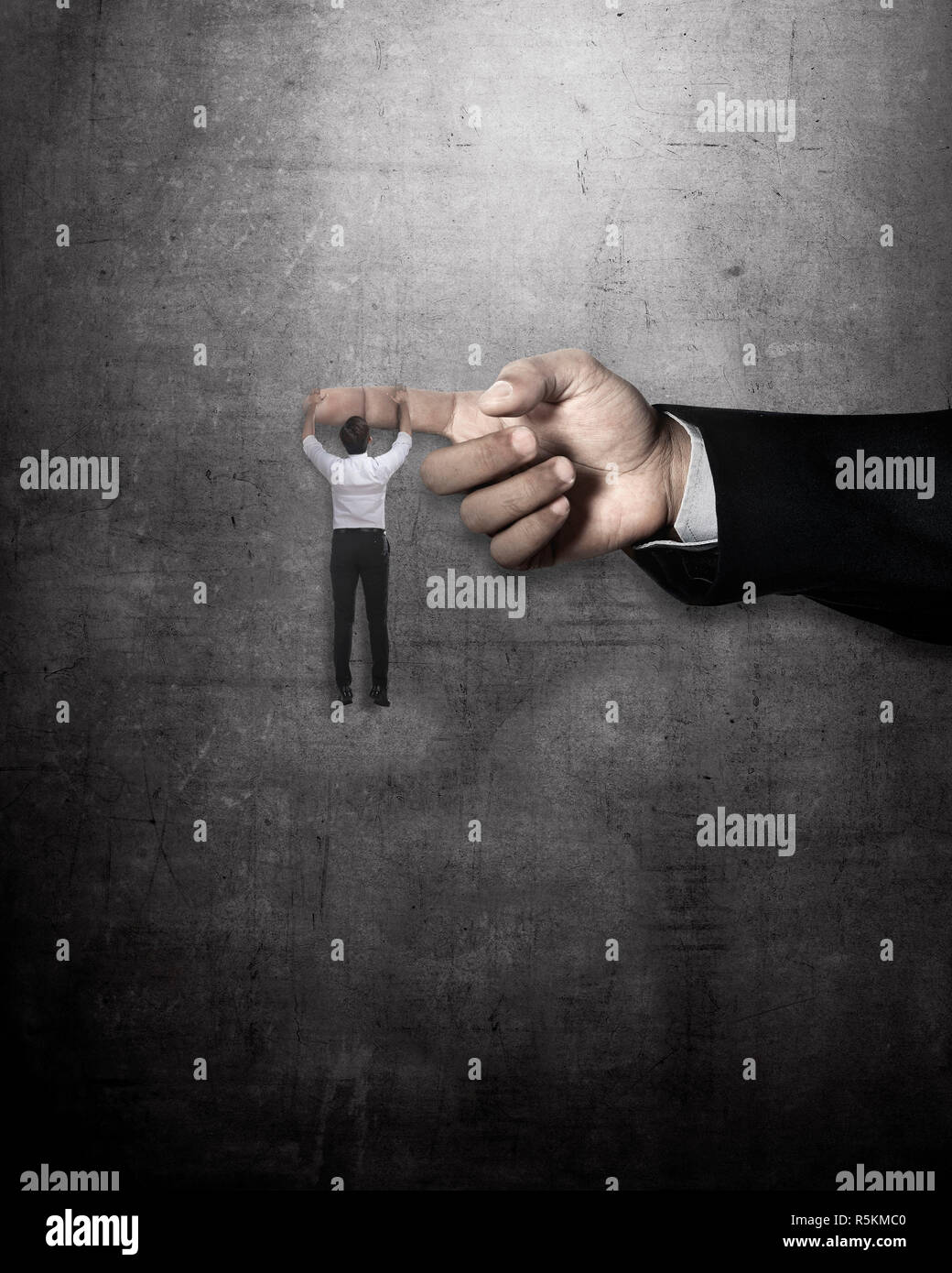Asian business man hang on large finger Stock Photo - Alamy