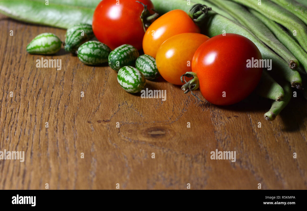 Cucamelons with red and orange tomatoes and runner beans Stock Photo ...