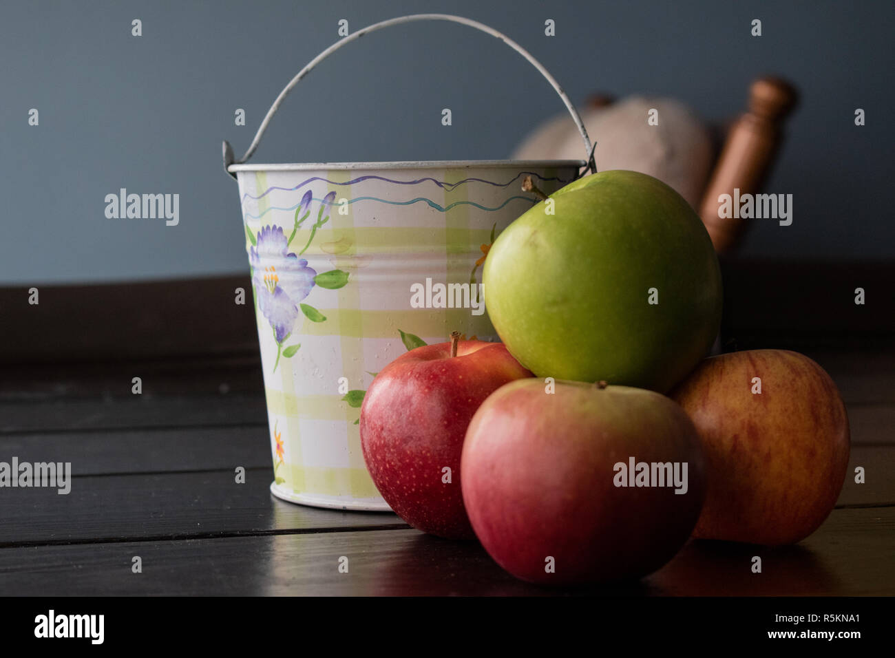 Apples and a Pail on Tabletop Stock Photo - Alamy