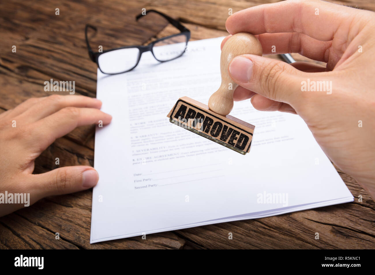 Businessman Holding Approved Stamp Over Contract Paper Stock Photo - Alamy