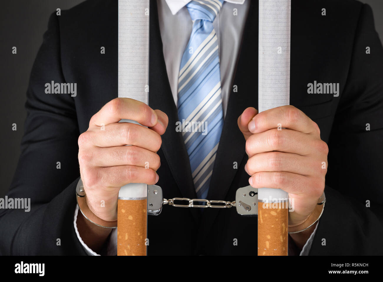 Handcuffed Businessman Holding Bars Stock Photo - Alamy