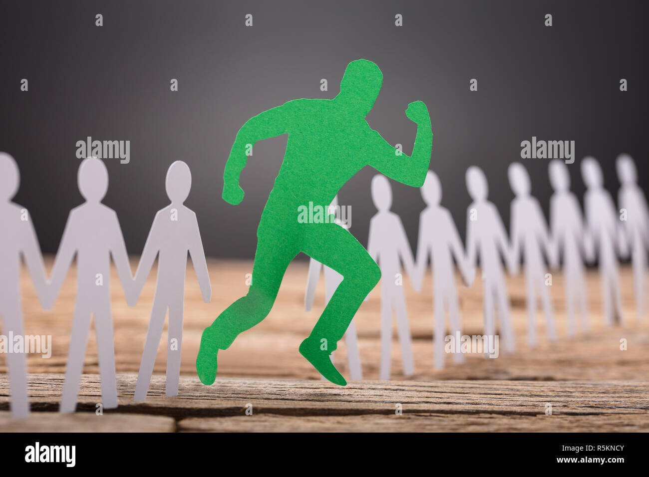 Green Paperman Standing Out Stock Photo - Alamy