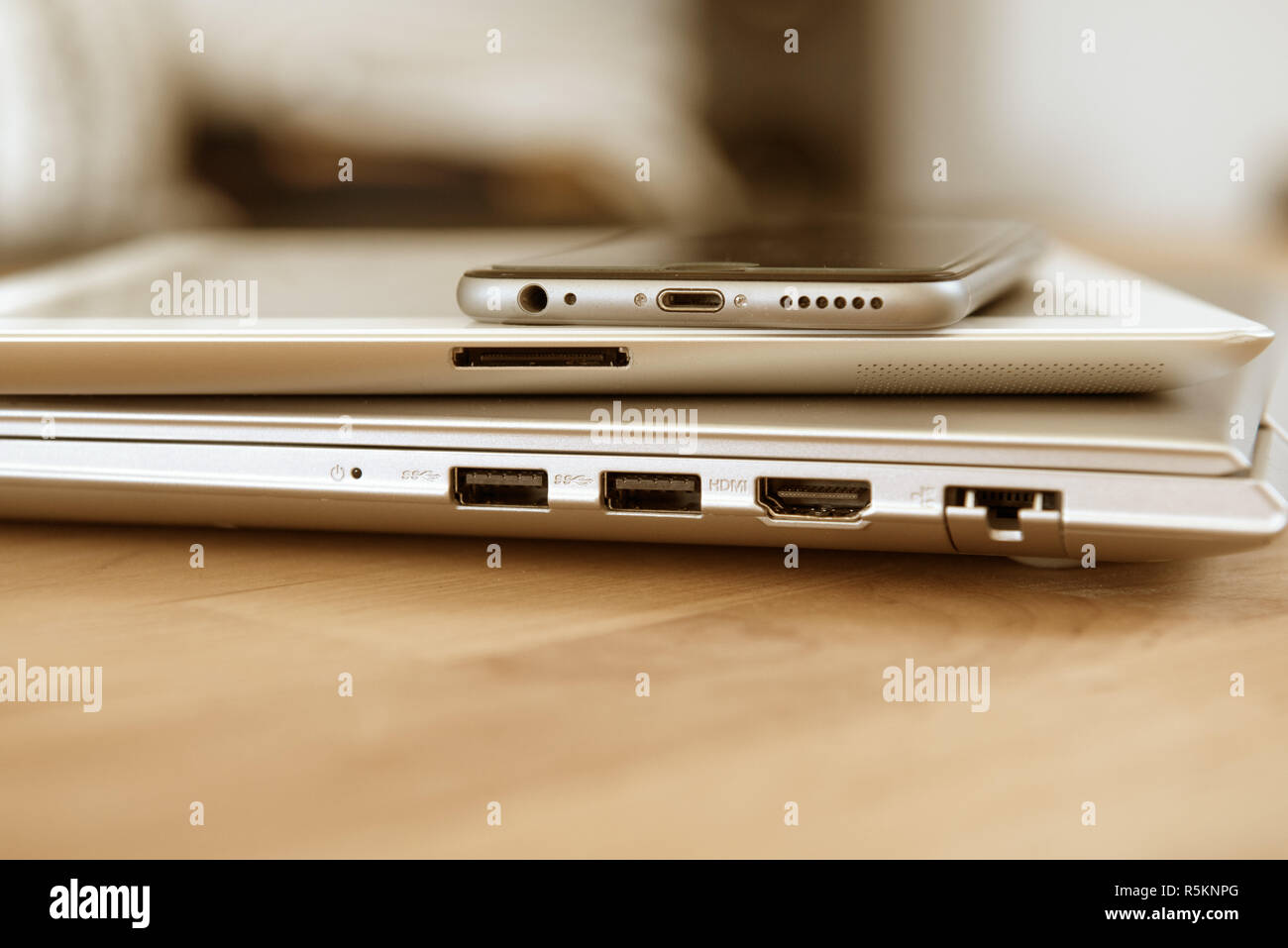 pile of different computers and phone Stock Photo - Alamy