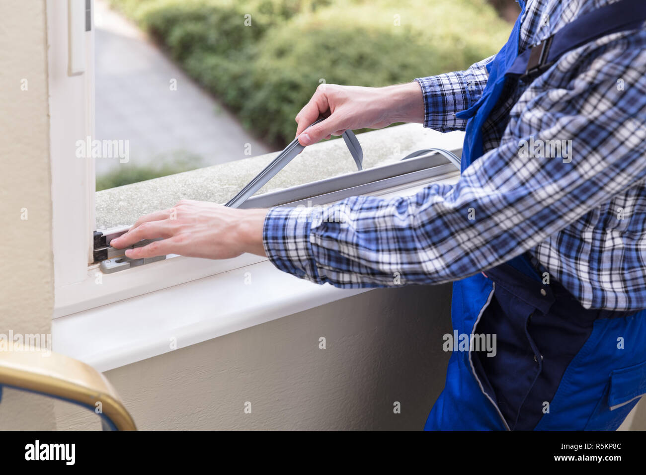 Repairman Fixing Window Stock Photo - Alamy