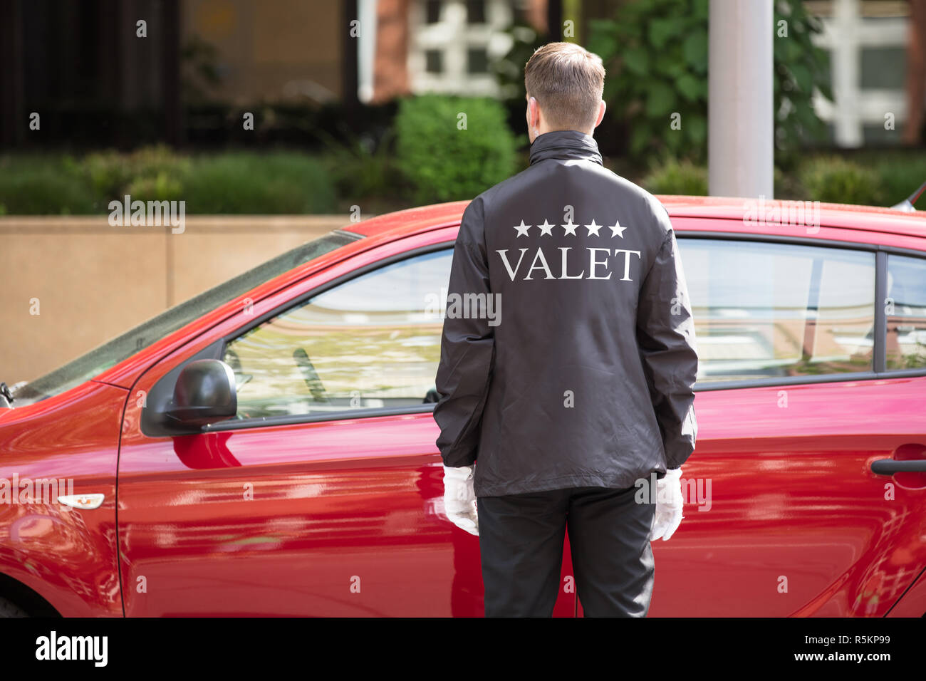 Valet Standing In Front Of Car Stock Photo - Alamy