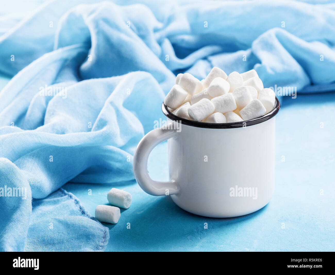 Marshmallows on blue background with copyspace Stock Photo - Alamy