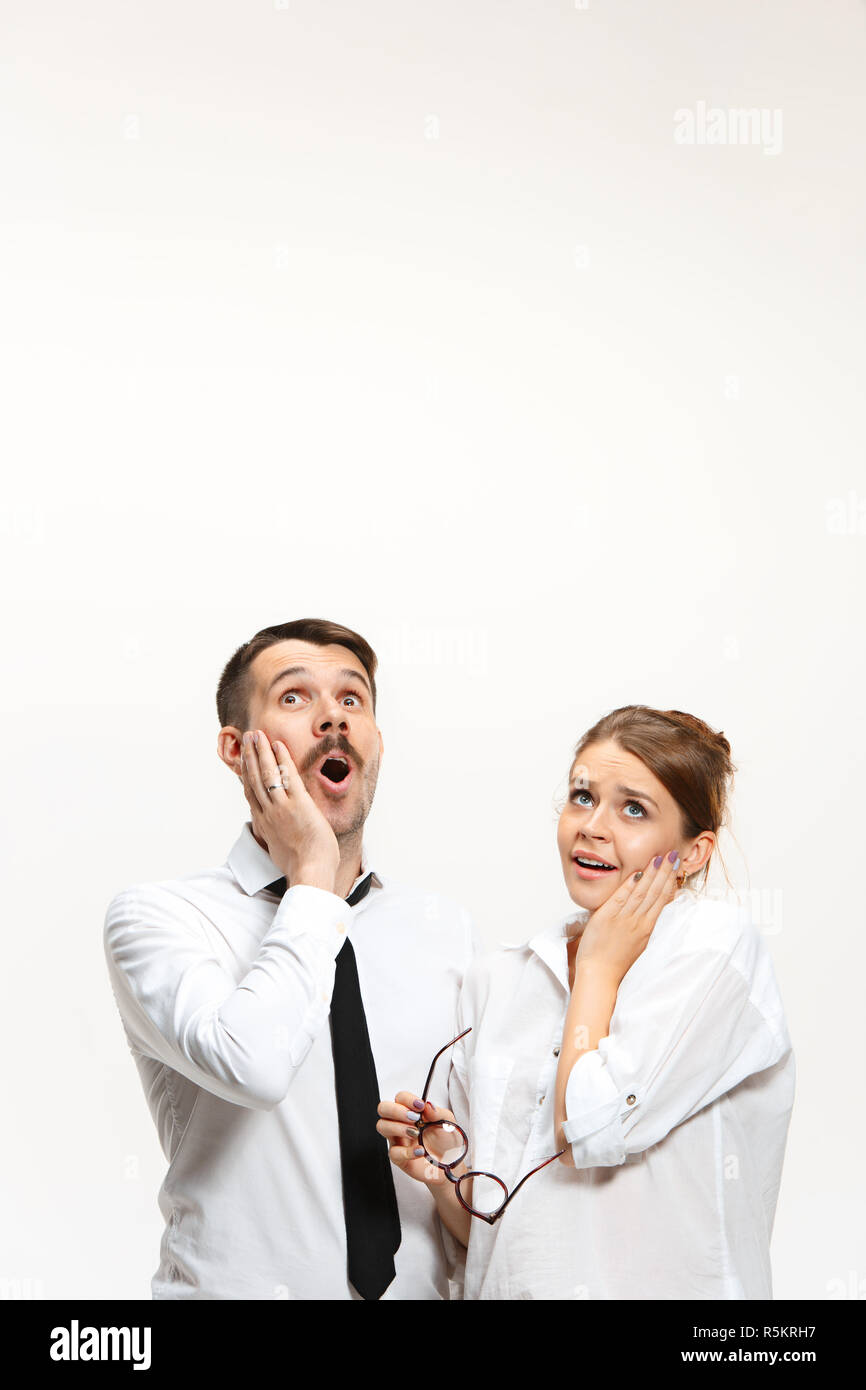 Successful business couple at the office looking up Stock Photo - Alamy