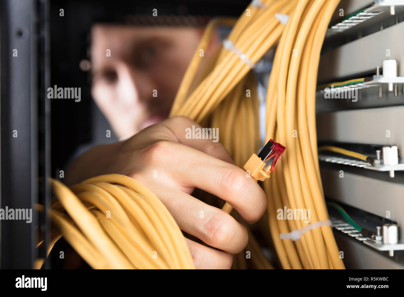 Engineer Plugging Cables Into Server Stock Photo - Alamy