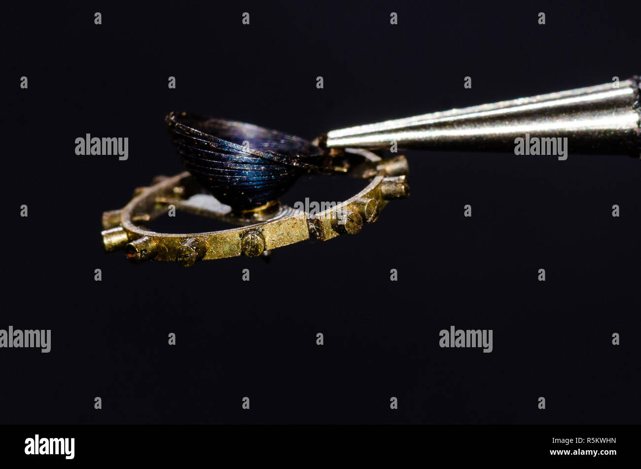 Watch Repair: Vintage Pocket Watch Hairspring Being Held by a Tweezers ...