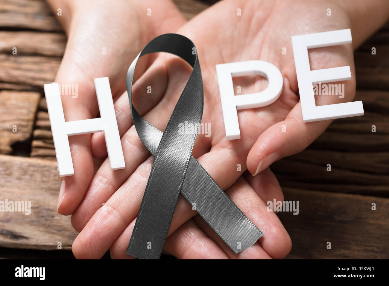 Hand Showing Ribbon With Hope Text Stock Photo - Alamy