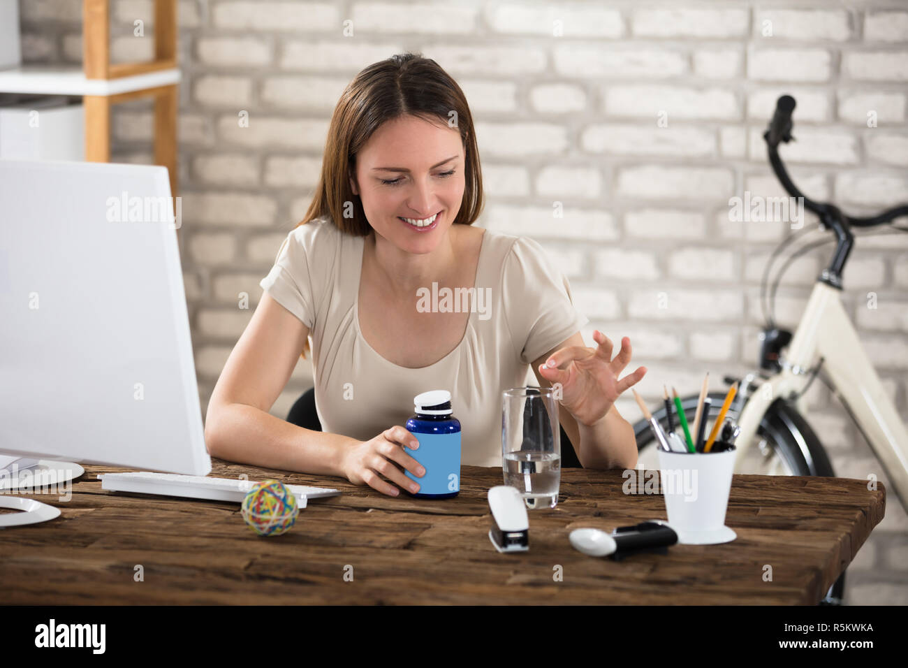 Beautiful woman putting pill hi-res stock photography and images - Alamy