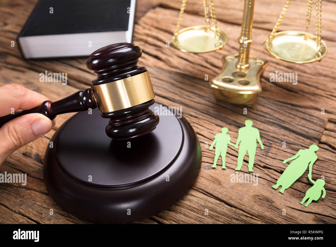 Judge's Hand Hitting Mallet By Separated Paper Family Stock Photo - Alamy