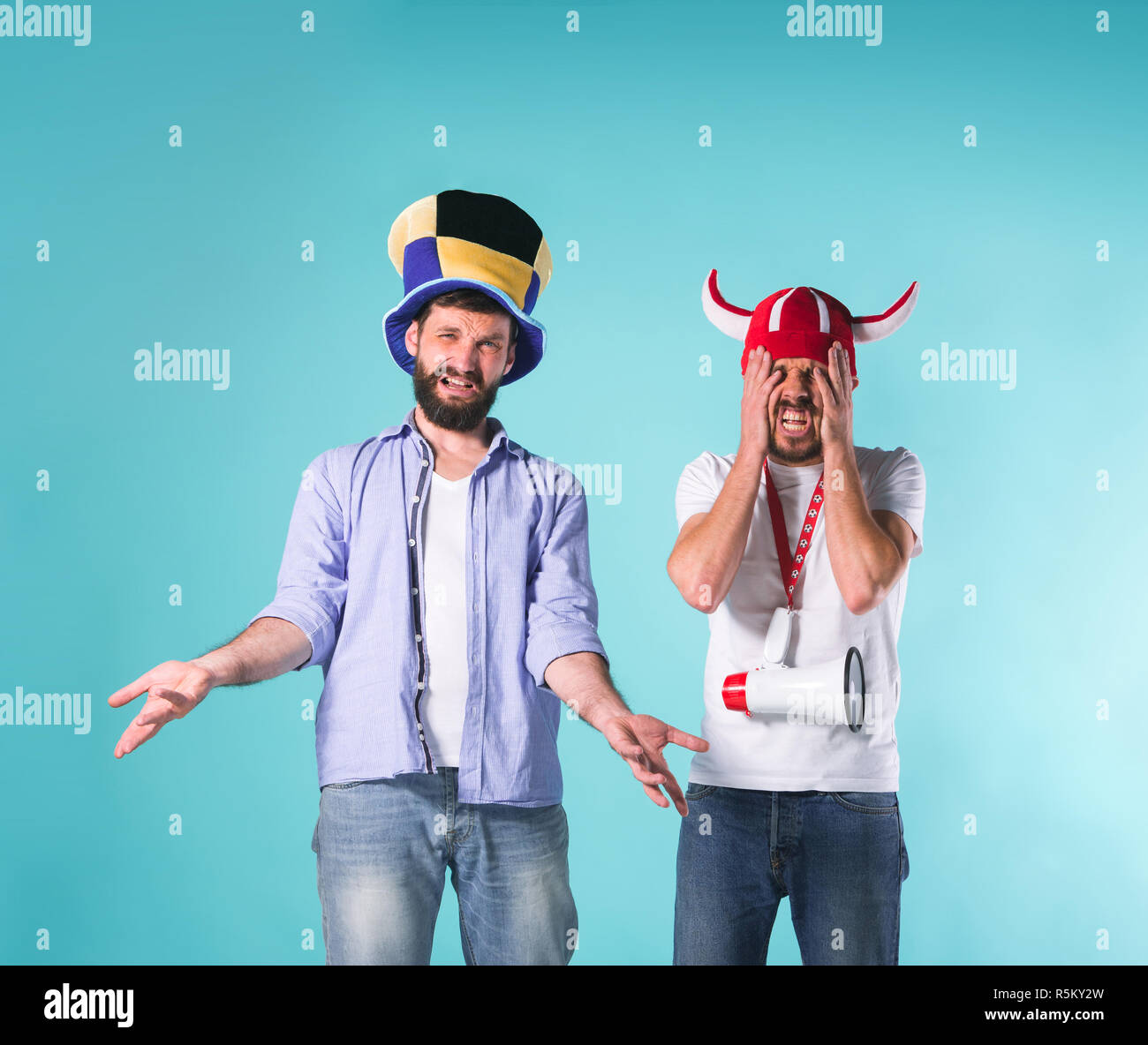 The two football fans over blue Stock Photo - Alamy