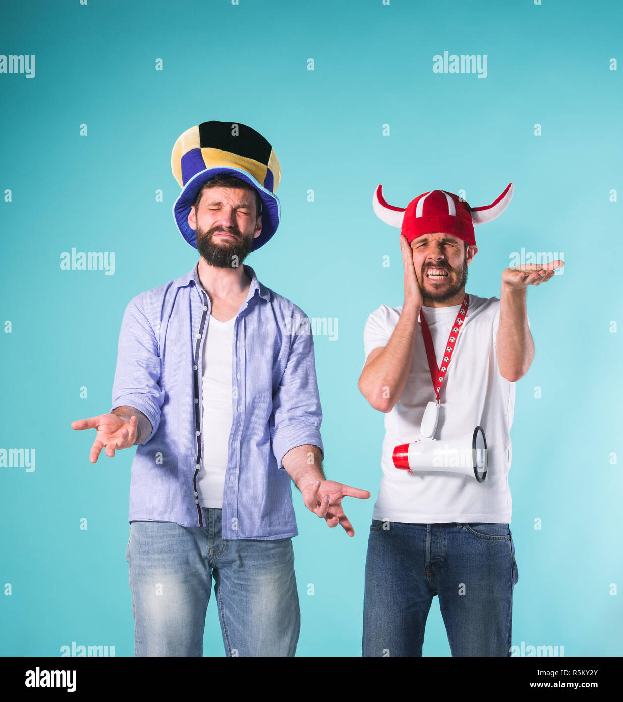 The two football fans over blue Stock Photo - Alamy