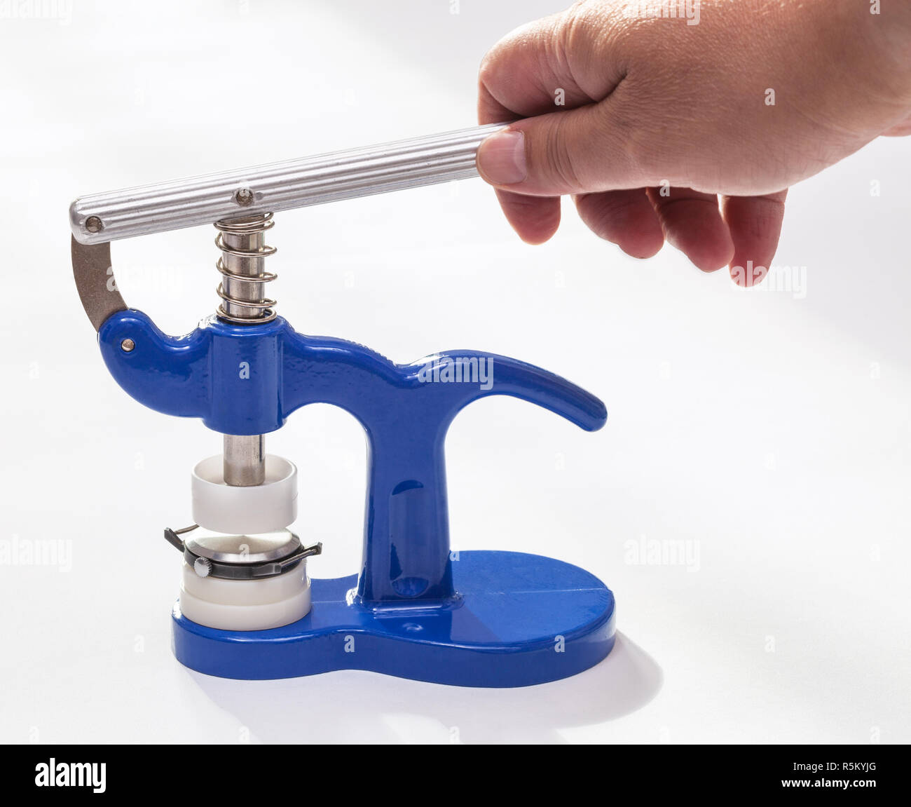 hand holds handle of manual press for wristwatch Stock Photo - Alamy
