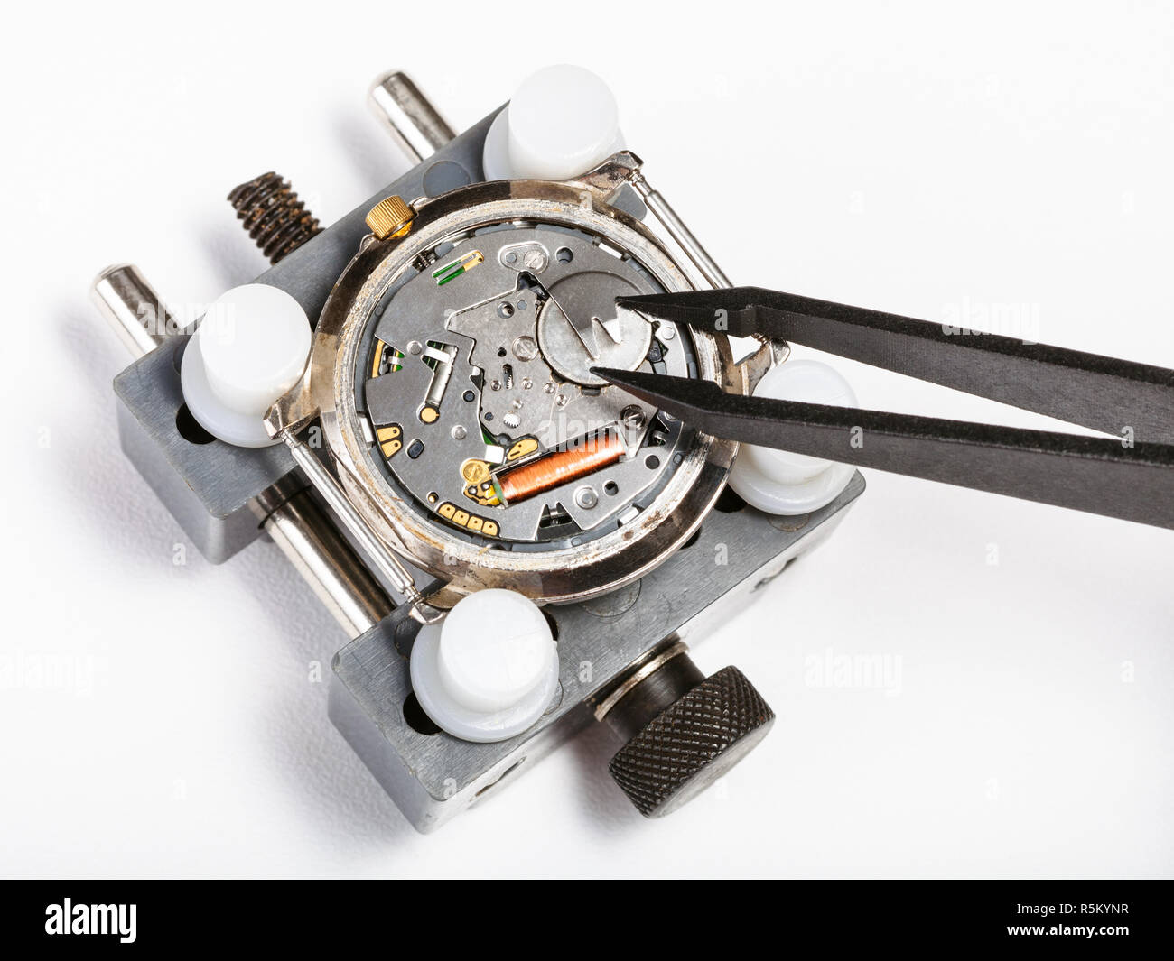 replacement battery in quartz watch with tweezers Stock Photo - Alamy
