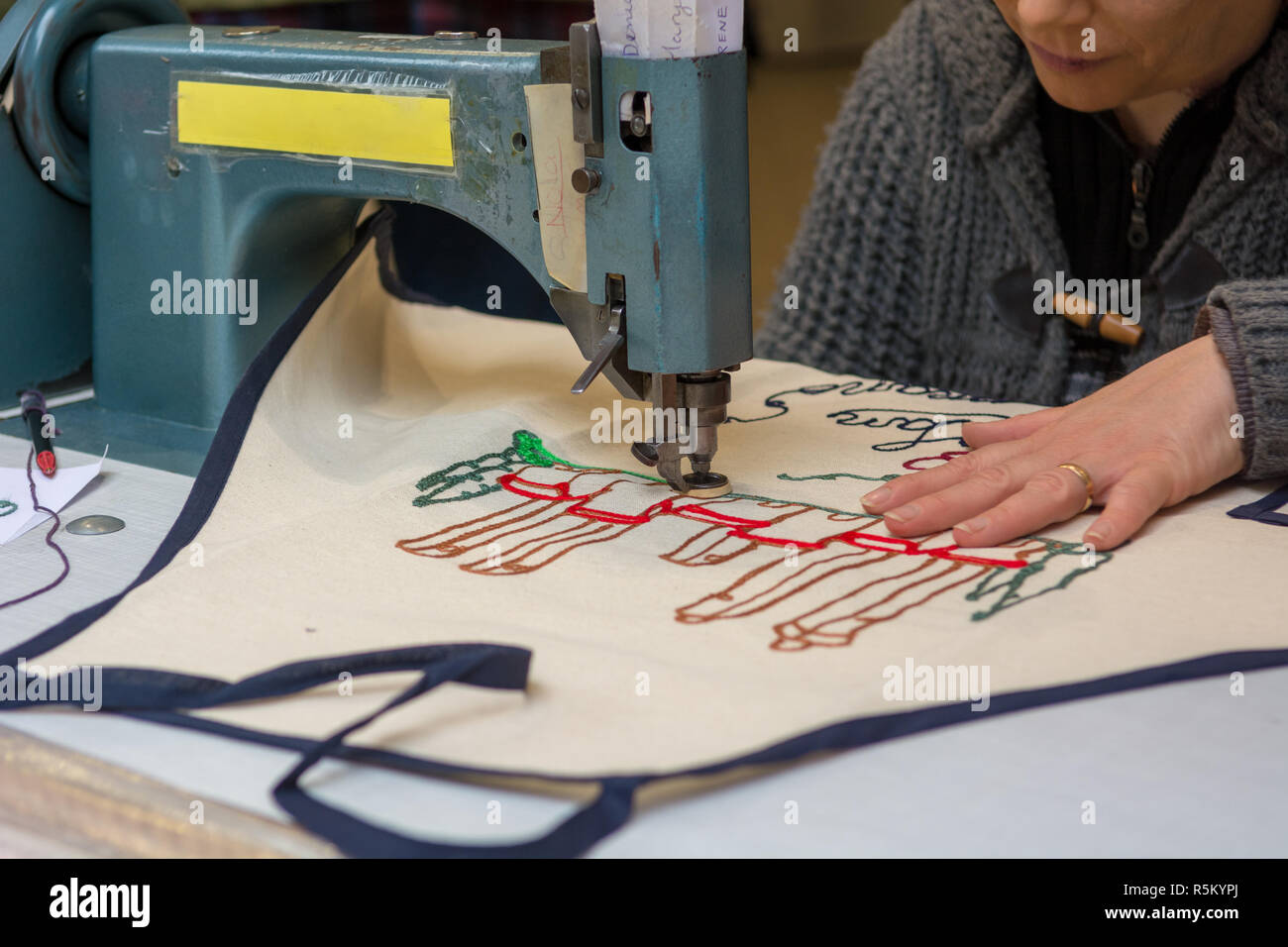 Person using sewing machine to draw a image onto fabric Stock Photo - Alamy