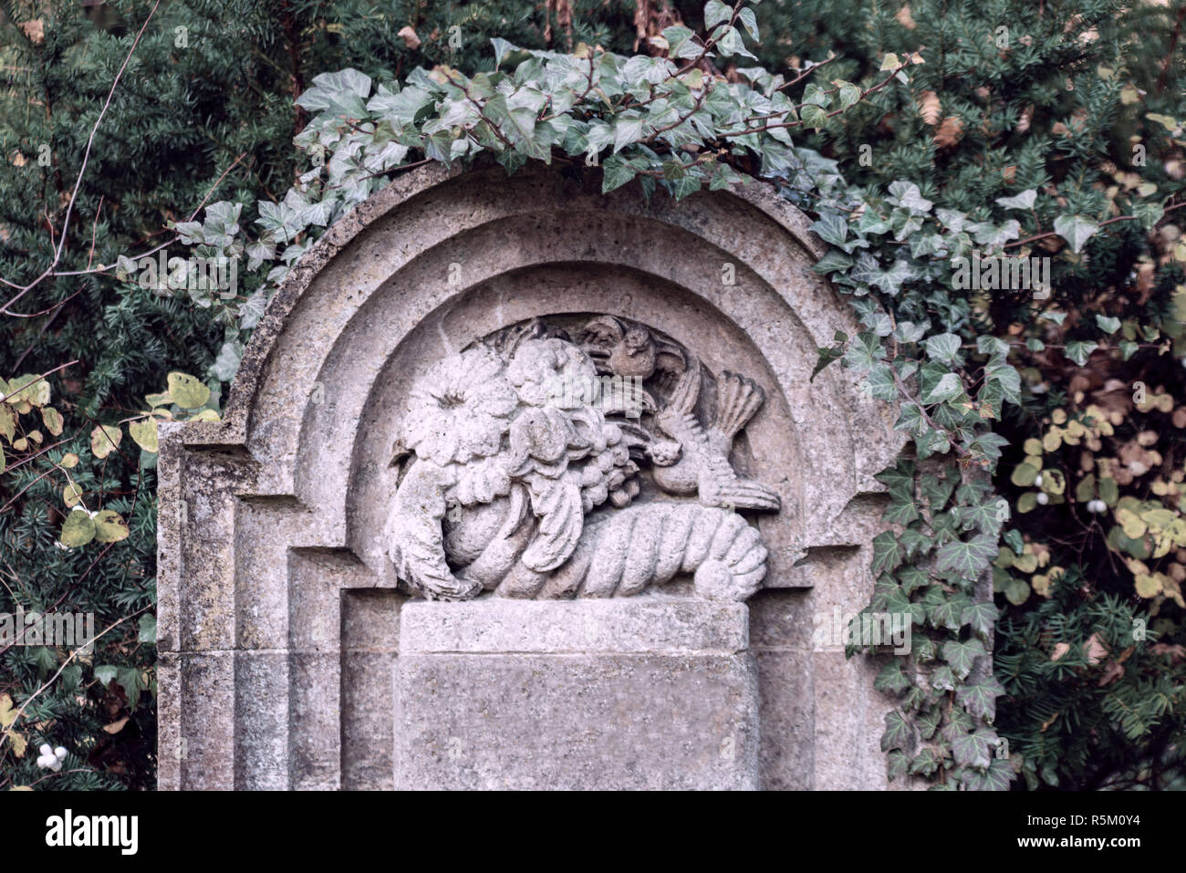 Old tombstone on german cemetery in Berlin Tegel showing birds, a dove ...