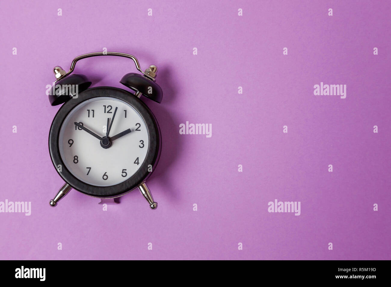 Ringing twin bell vintage classic alarm clock Isolated on purple violet ...