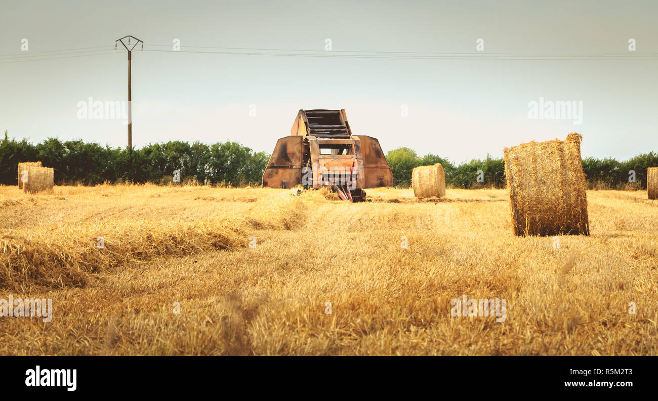Remains of a round baler after a fire Stock Photo - Alamy