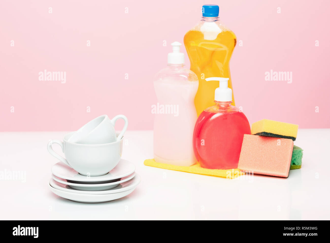 Several plates, a kitchen sponges and a plastic bottles with natural ...