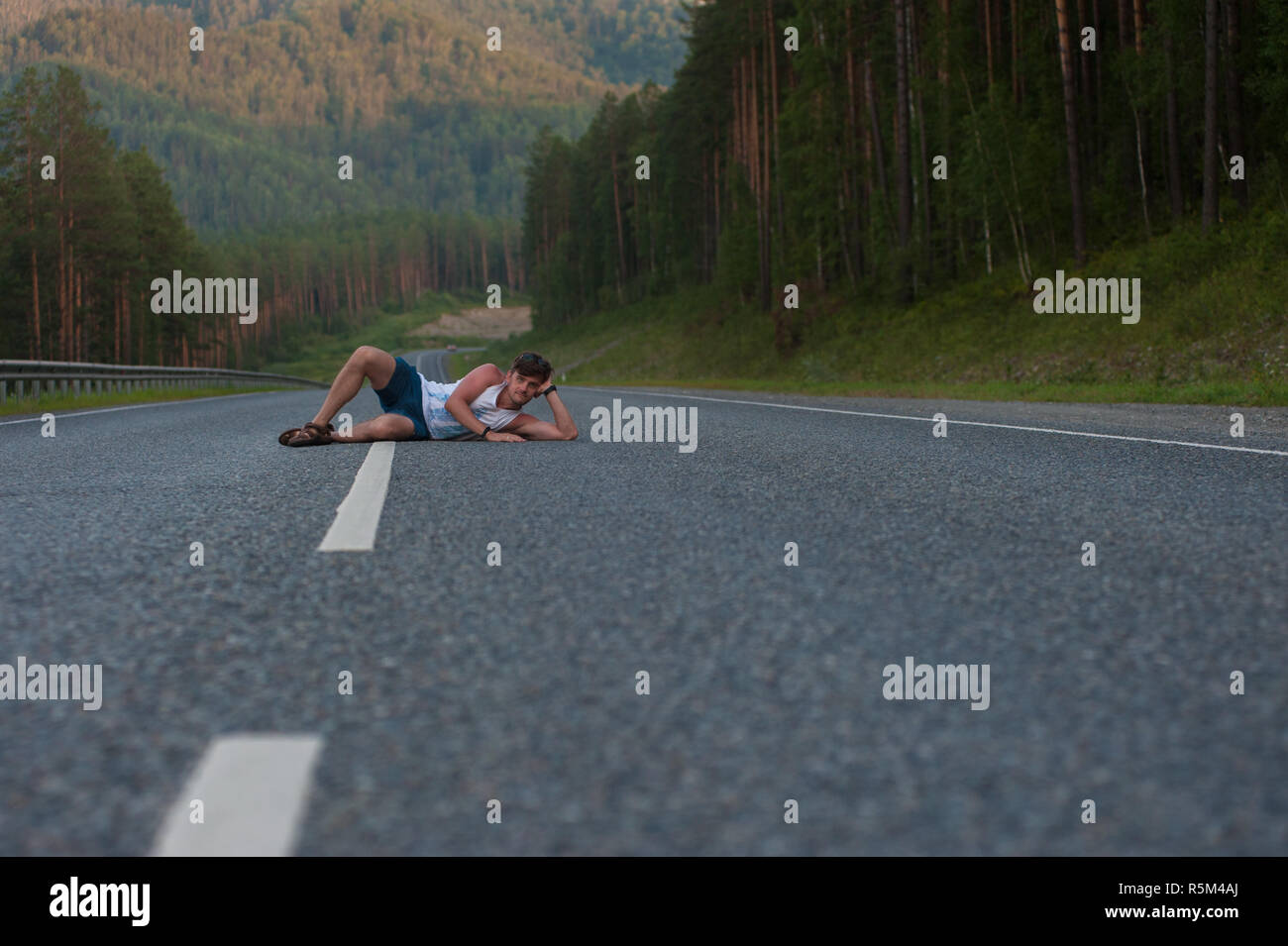 Man laying on the road Stock Photo - Alamy
